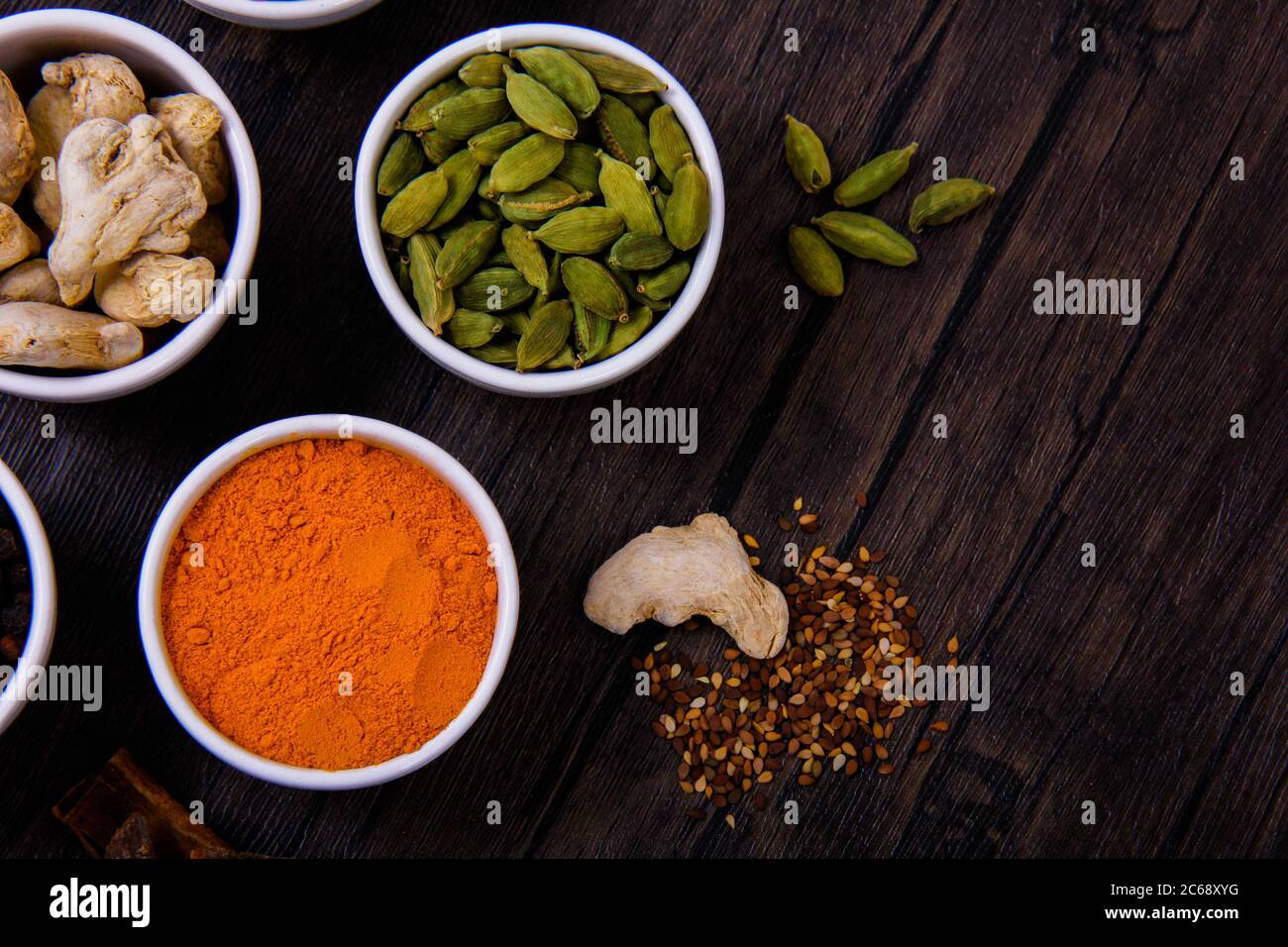 Different types of spices in small dishes with different colors ...