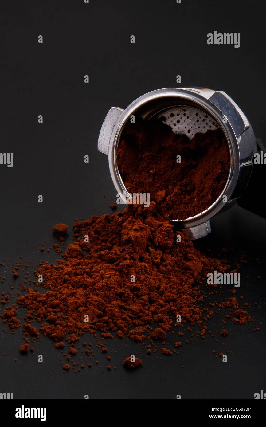 Coffee beans and coffee powder in the container and outside together ...