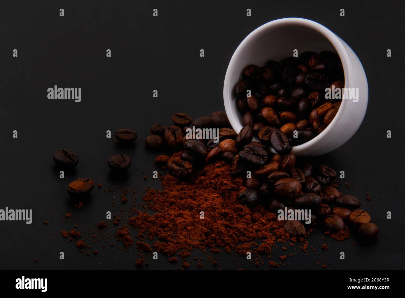 Coffee beans and coffee powder in the container and outside together ...