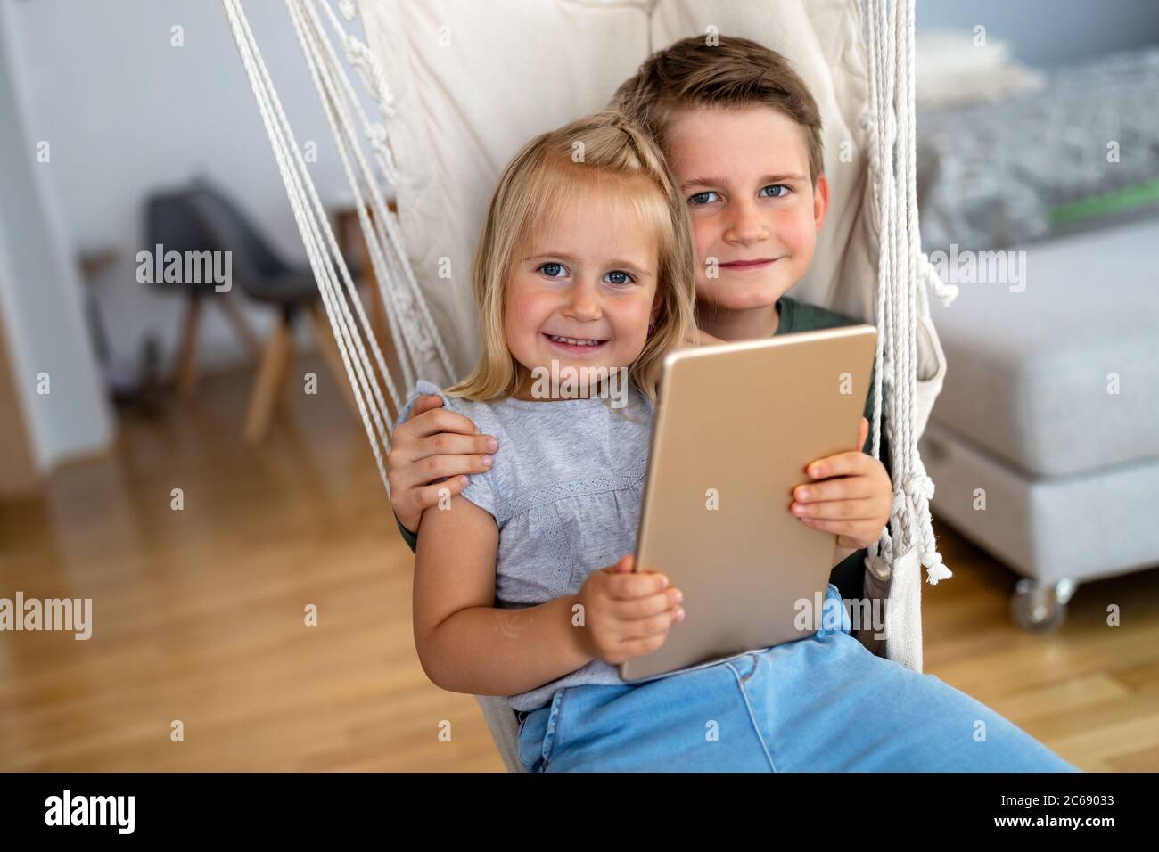 Childhood, technology and family concept. Little kids playing with ...