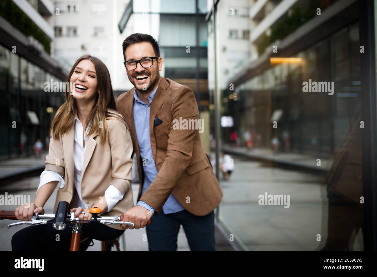 Attractive young business couple embracing at street Stock Photo - Alamy