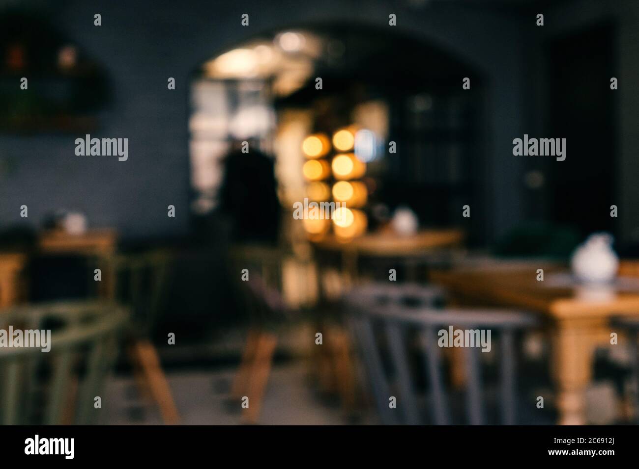 Restaurant blurred background. Cafe with yellow light window. Dark and ...