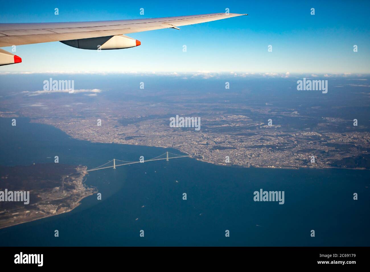 aerial view from plane window over Akashi-Kaikyo Bridge crossing osaka ...