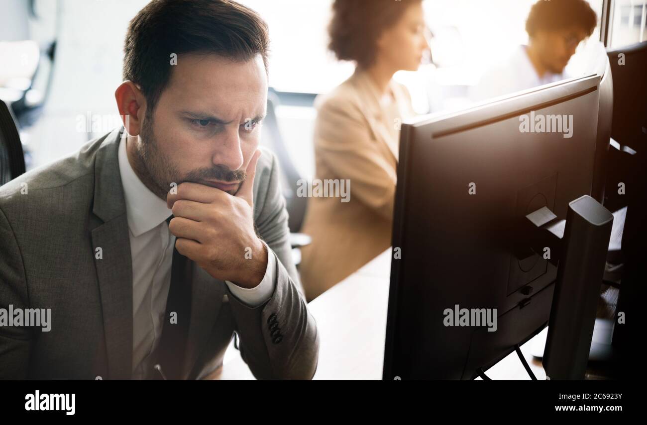 Serious businessman thinking hard of problem solution working late in ...