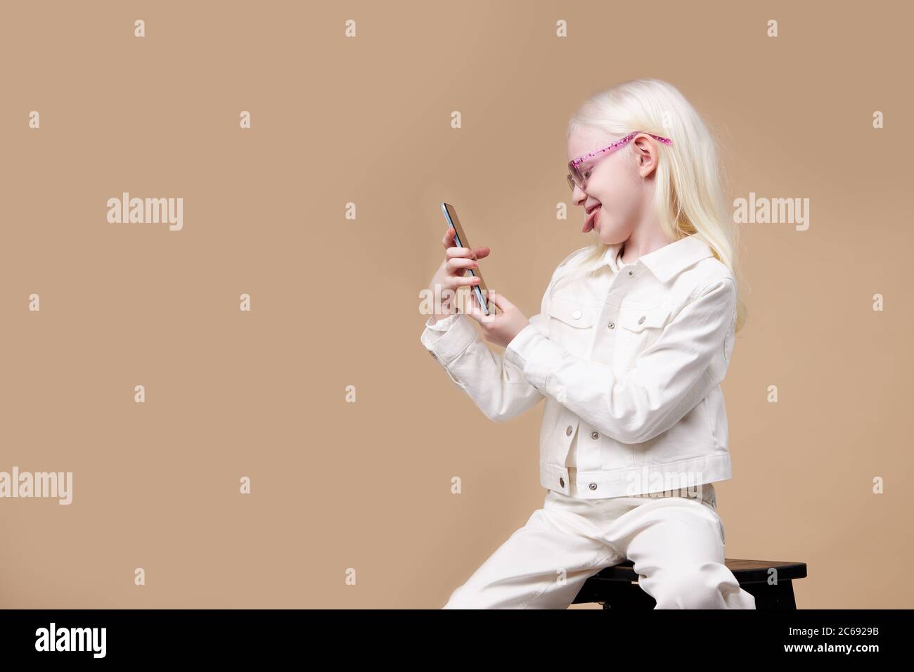 adorable albino girl with charming appearance take photo on mobile ...