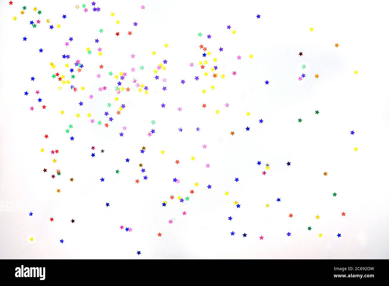 Multi-colored stars on a white background. Festive background of ...