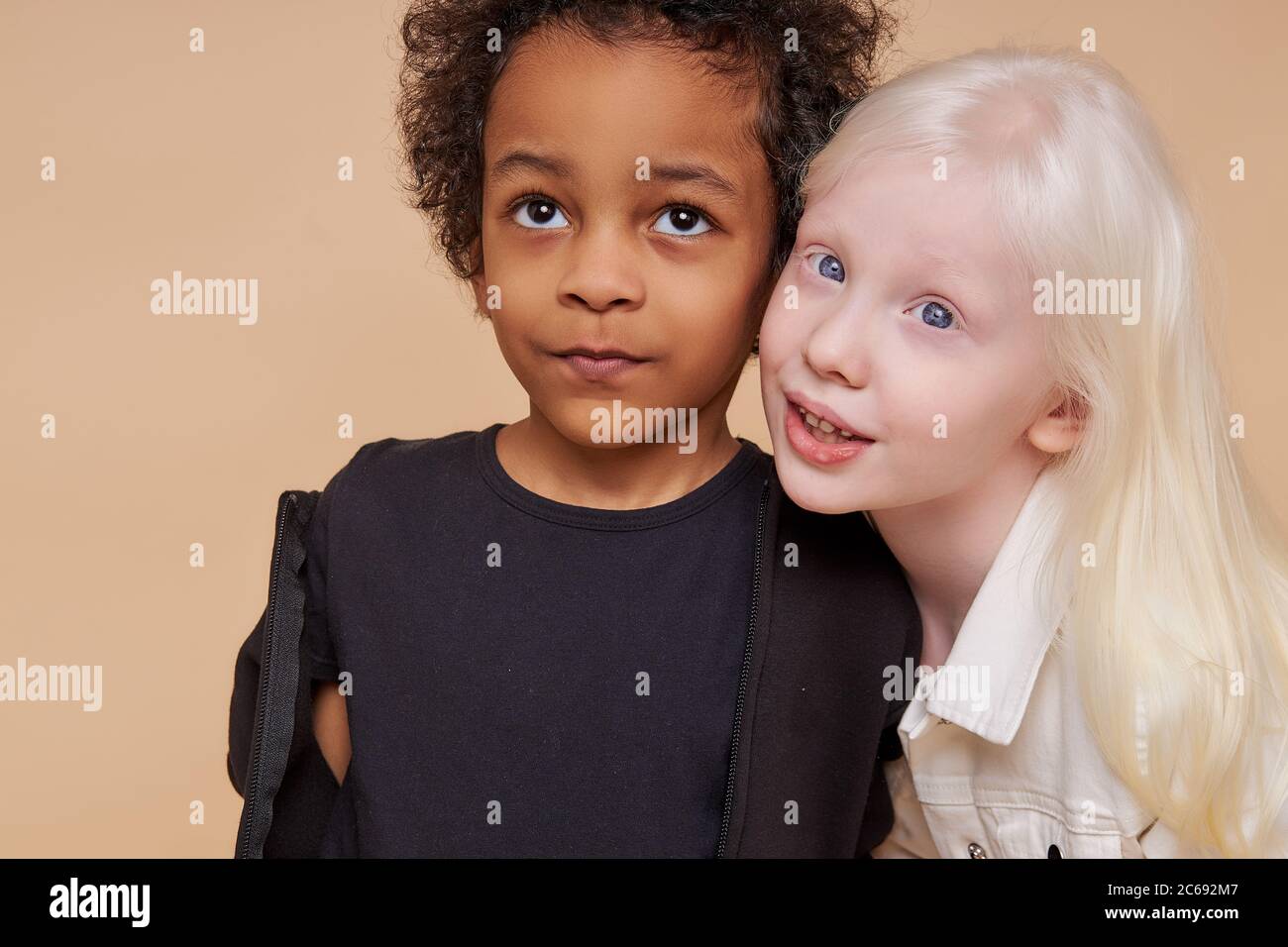 portrait of friendly diverse children posing at camera isolated ...