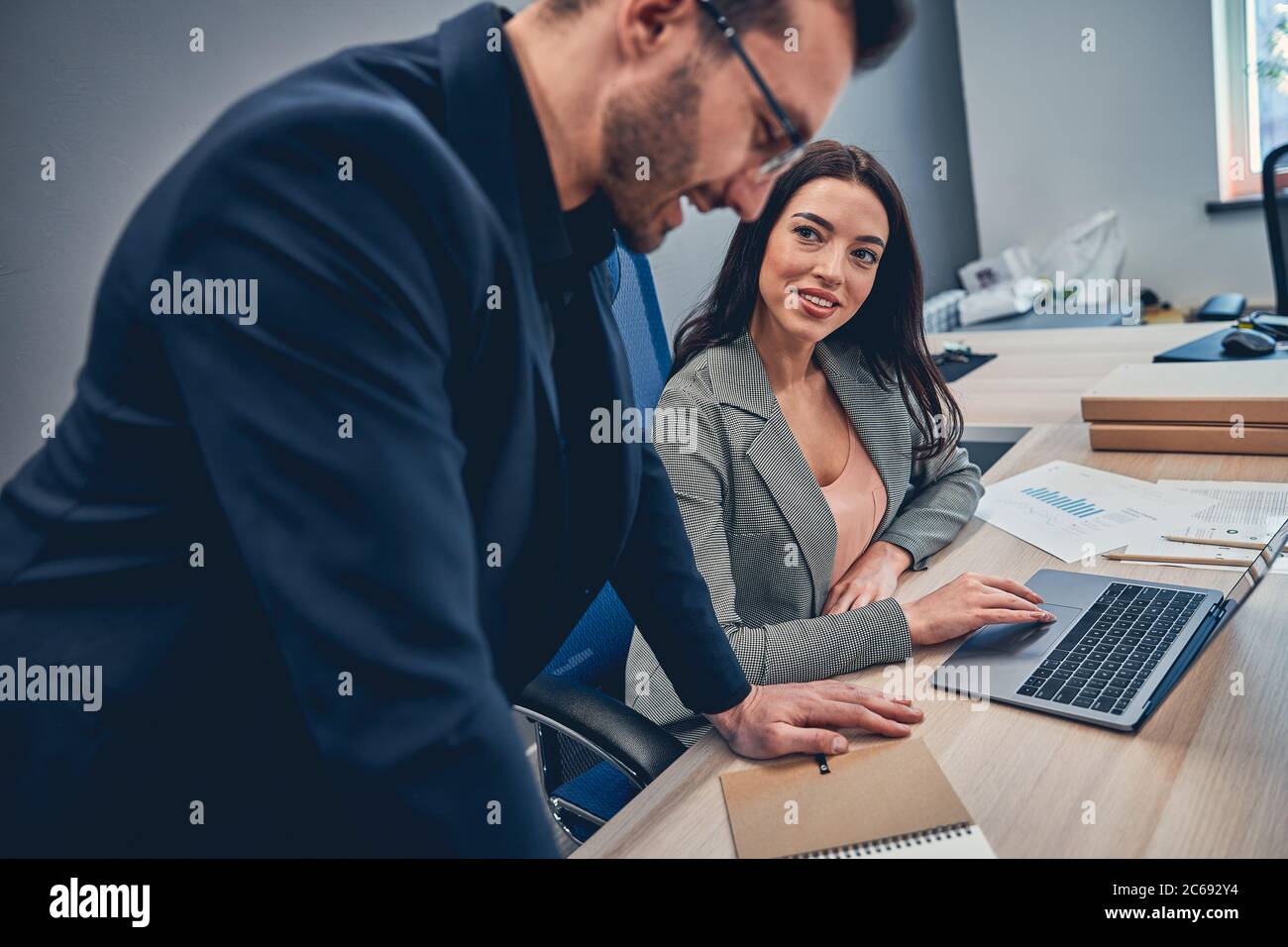 Two business people sitting at conference table and discussing during ...