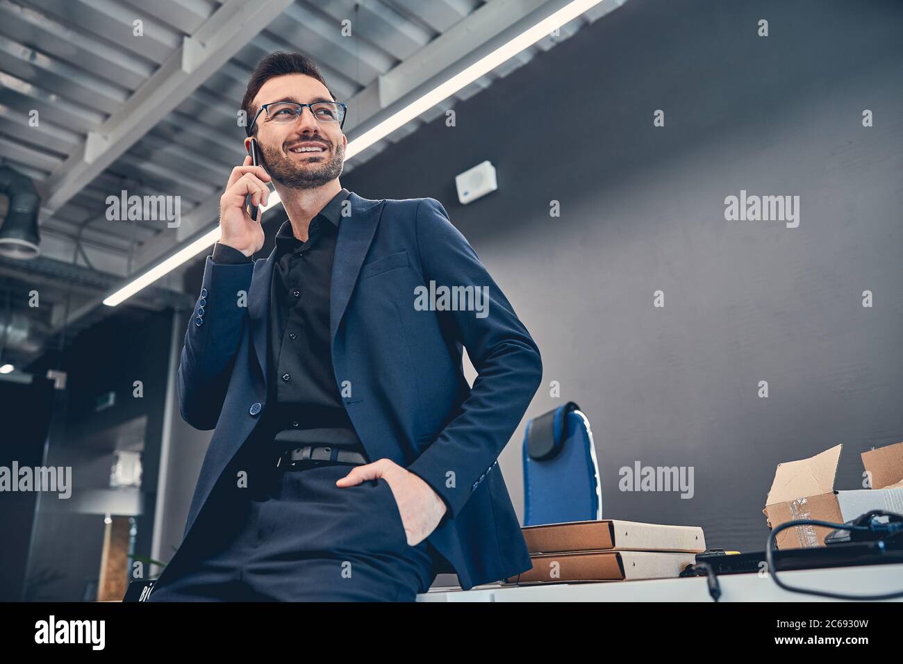 Handsome worker making call sitting hi-res stock photography and images ...
