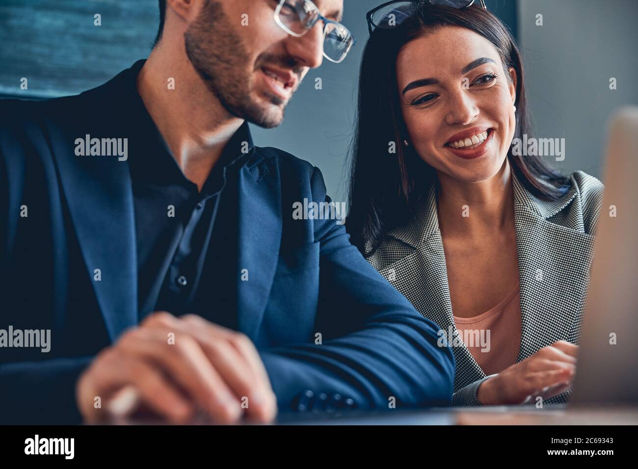 Young couple of manager working together on project in office Stock ...