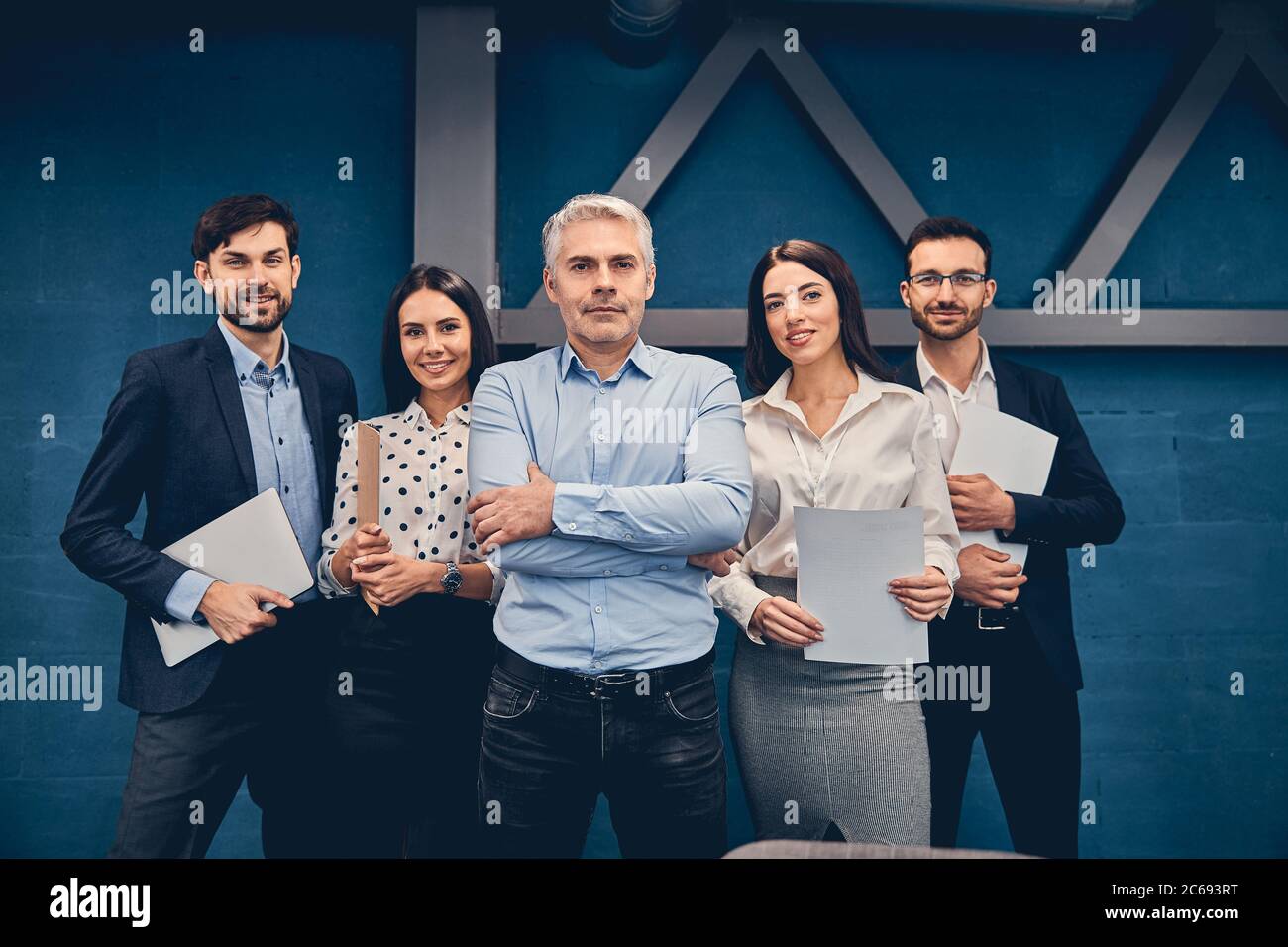 Boss leader standing and teaching his team in modern office Stock Photo ...
