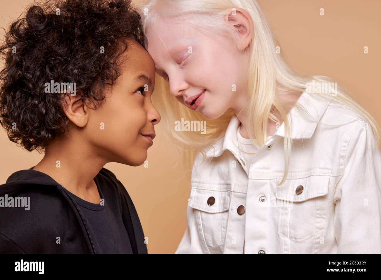 portrait of friendly children, tender dark-skinned afro and albino kids ...
