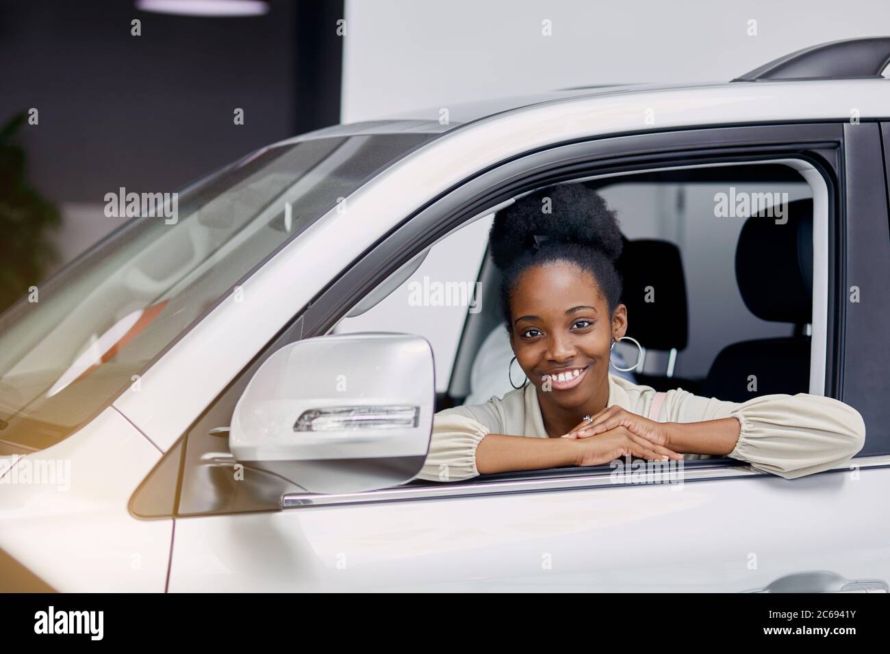 happy young black woman in dealership, beautiful lady came to buy ...