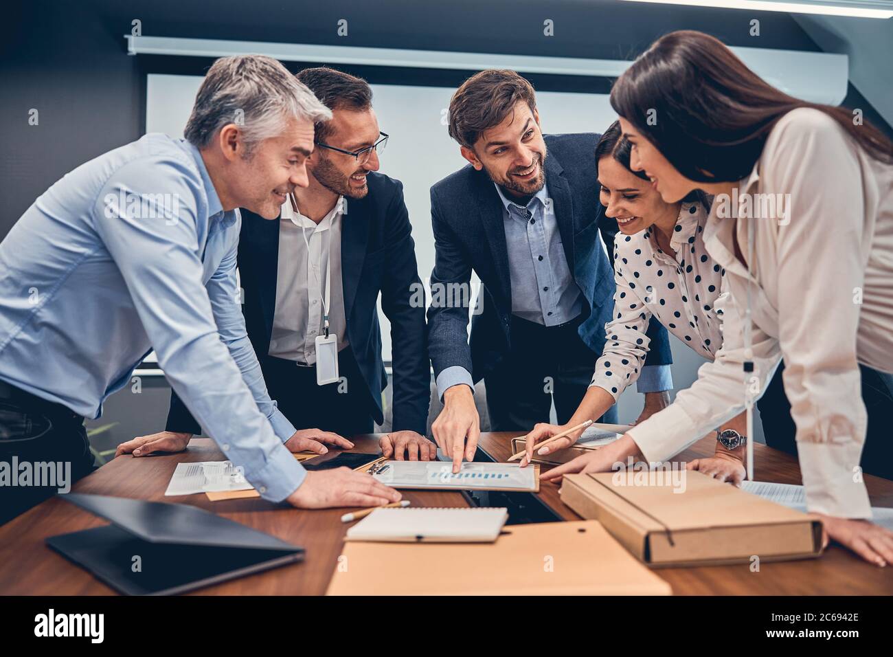 Group of expert dressed in formal wear developing advertising campaign ...
