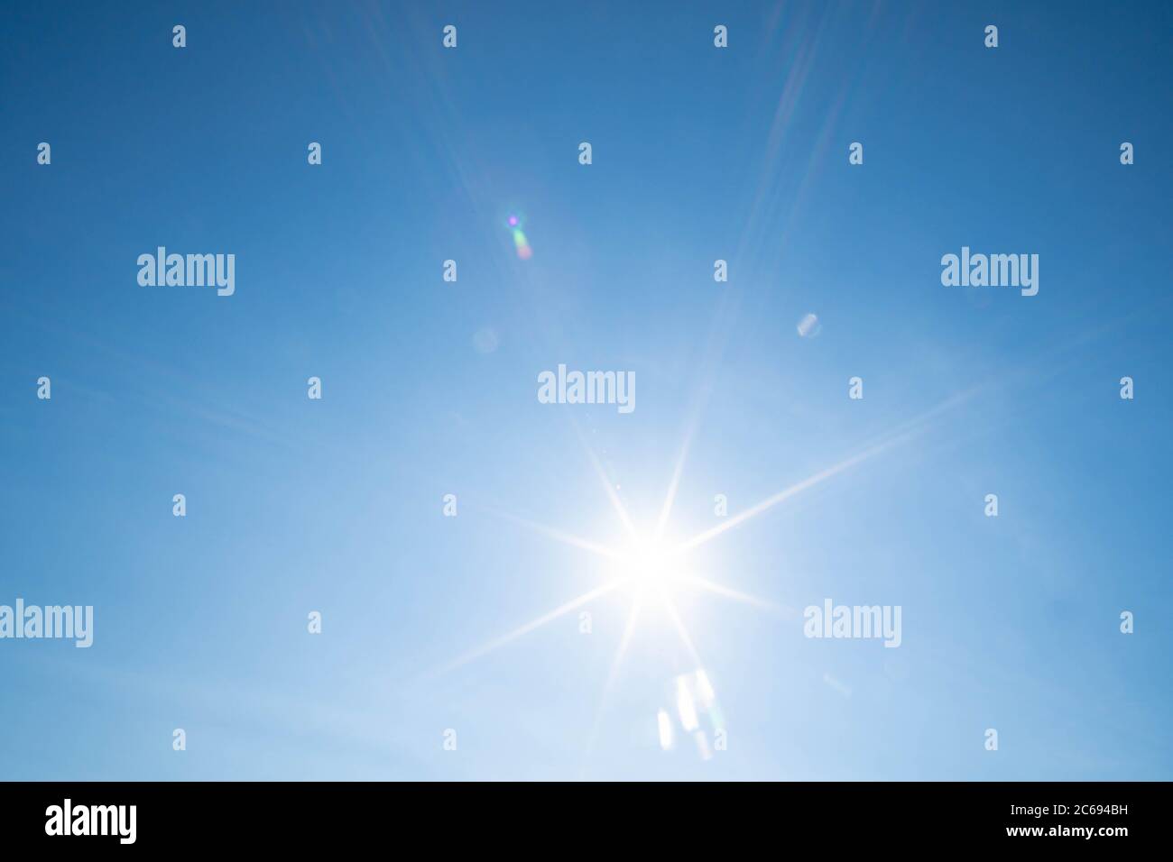 Sharp sunbeams on a cloudless day in summer and holiday time. Clear ...