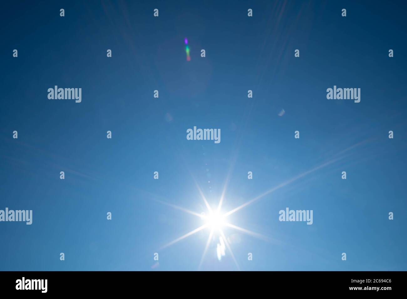 Sharp sunbeams on a cloudless day in summer and holiday time. Clear ...