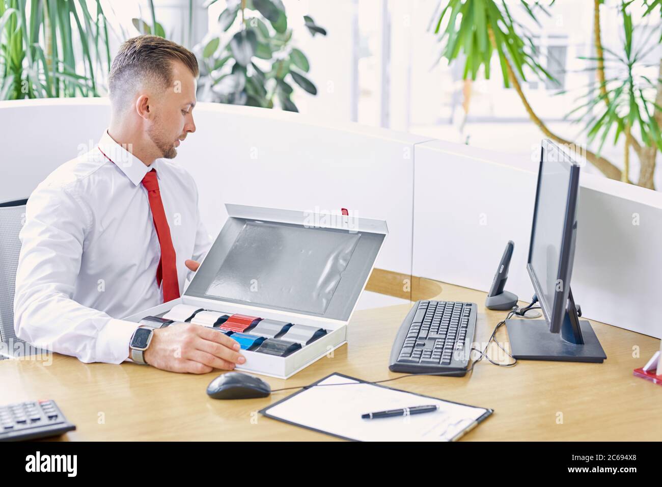 young professional salesman represents a color palette to buyers ...