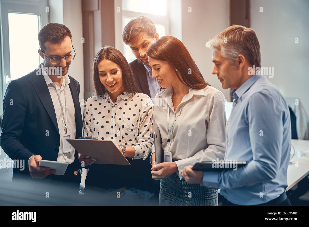 Female leader showing report for her colleagues Stock Photo - Alamy