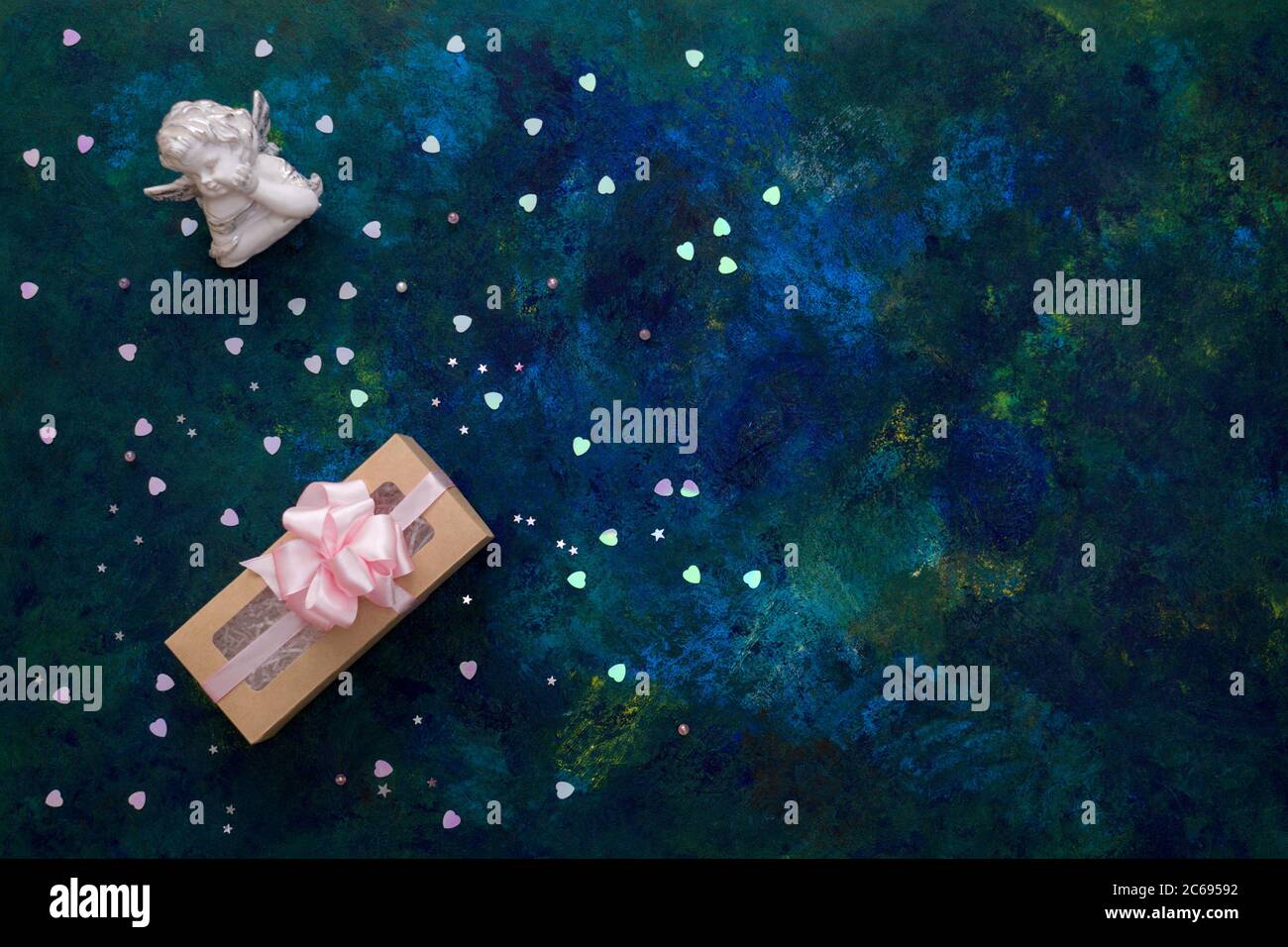 Valentines day concept. Cupid and gift box with pink bow, pink hearts ...