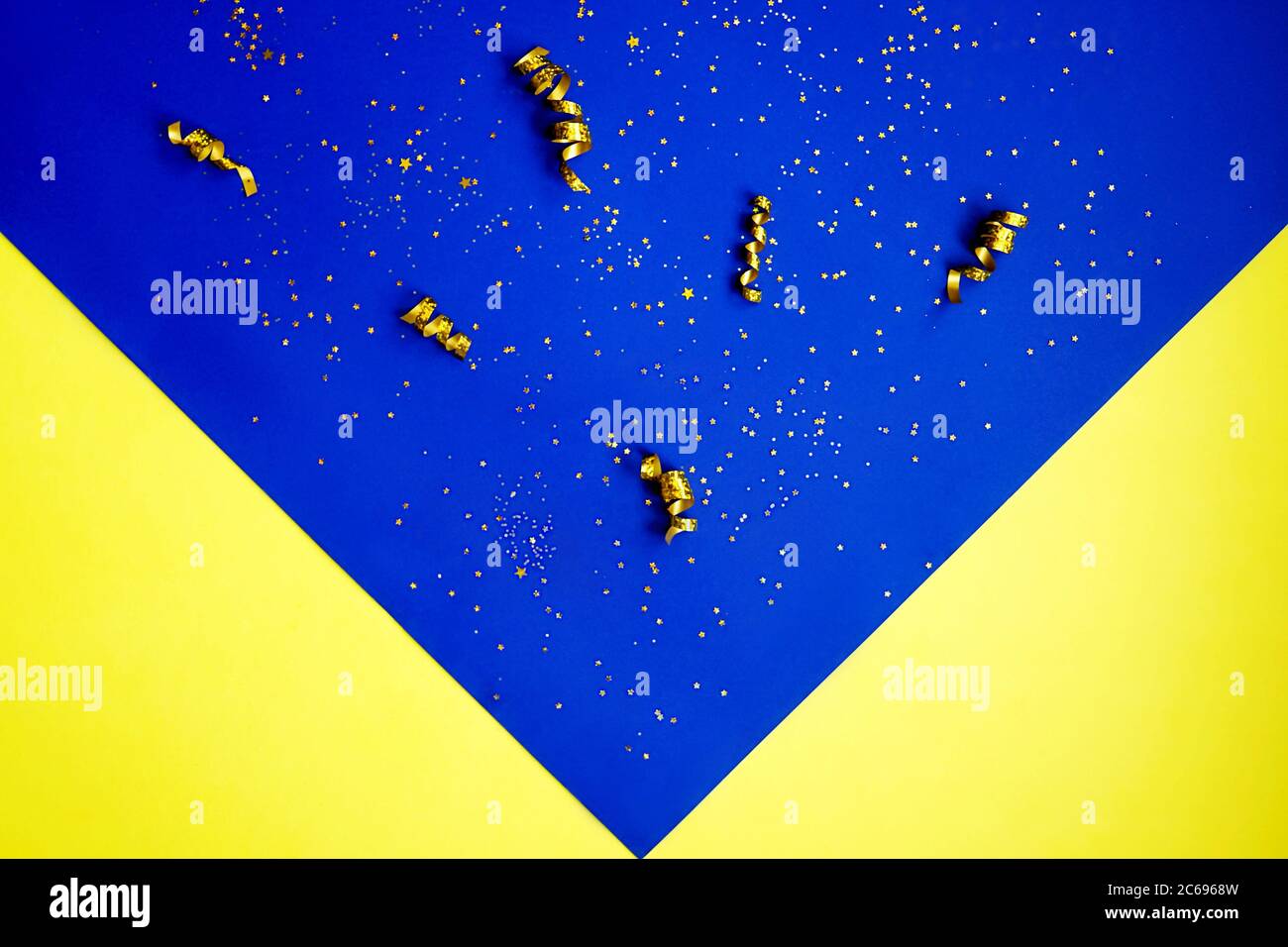 Golden decorations and sparkles on bright blue yellow background. As ...