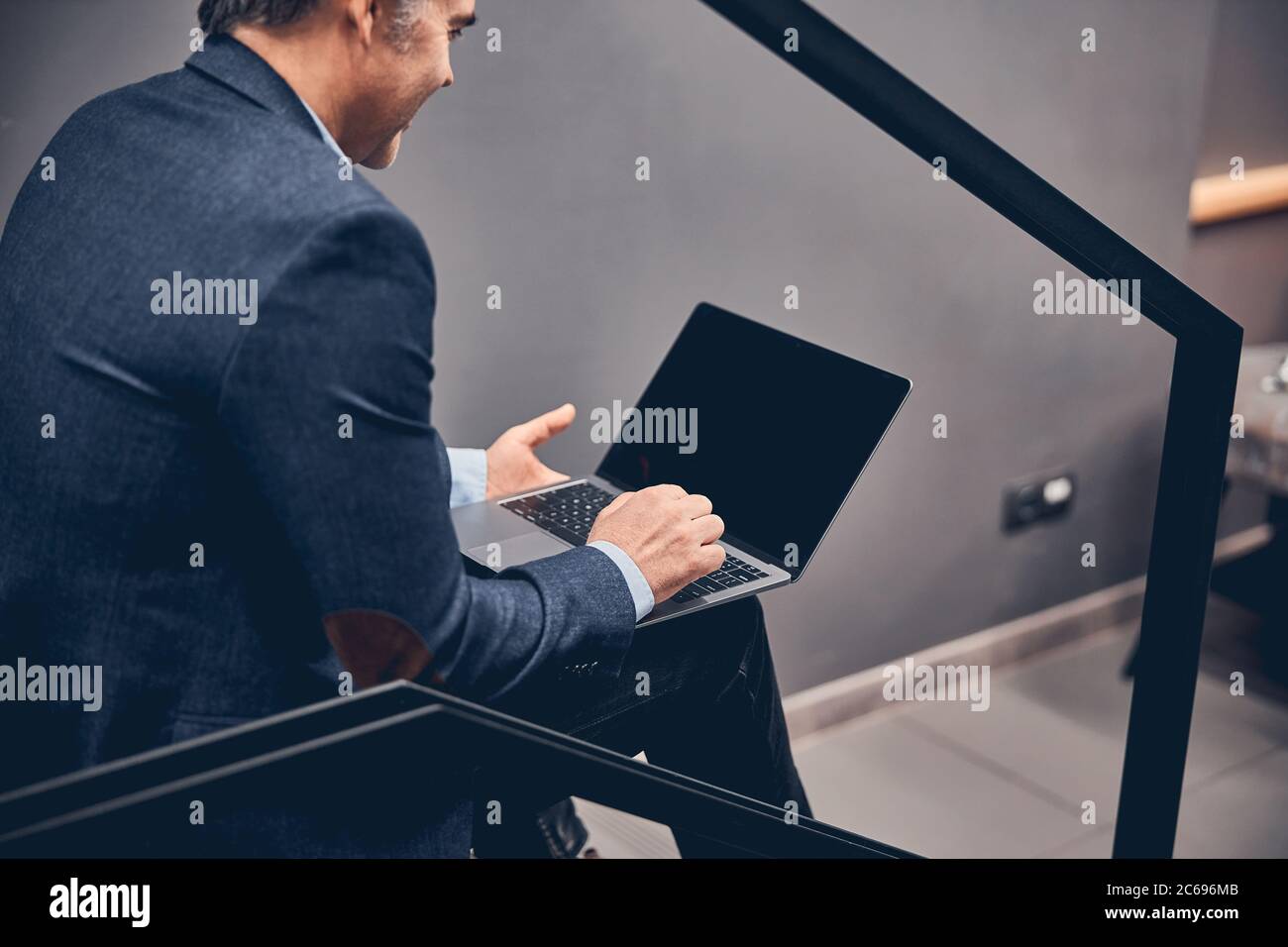 Back view of adult man working on his laptop Stock Photo - Alamy