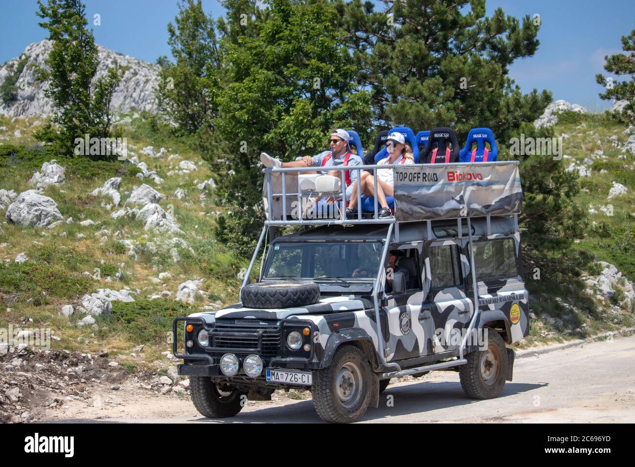 Modified Land Rover with a cage on top of it for 6 people driving ...