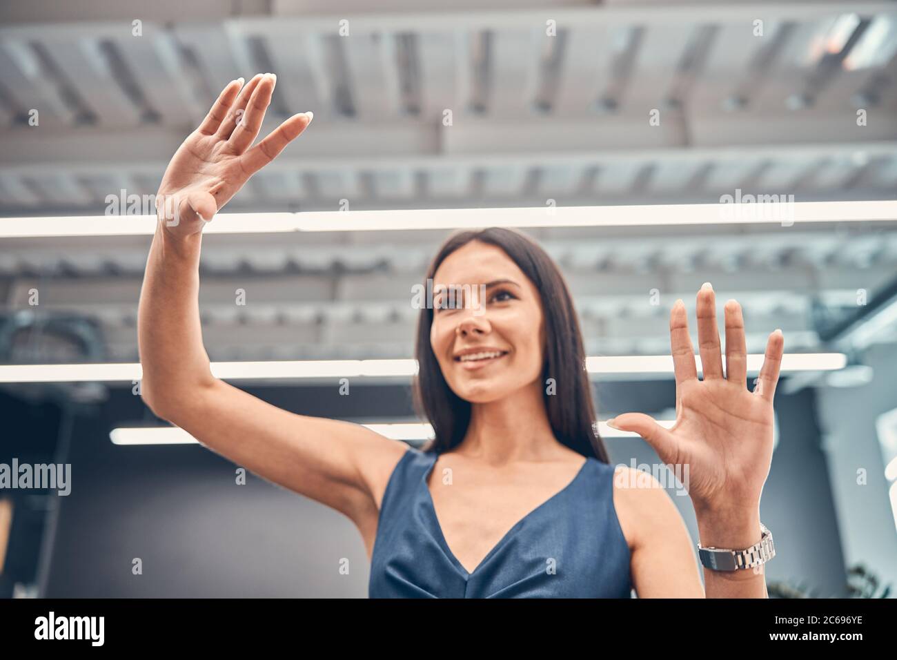 Young woman hand up in the office workplace Stock Photo - Alamy