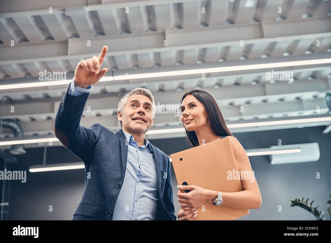 Business man with his secretary gesturing at the office building Stock ...