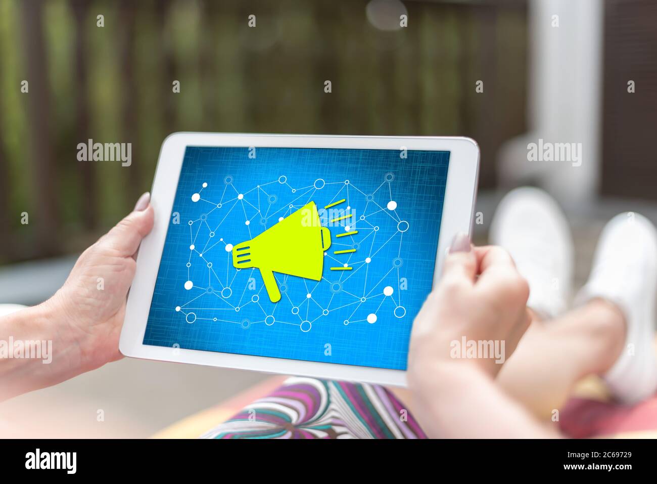 Female hands holding a tablet with communication network concept Stock ...