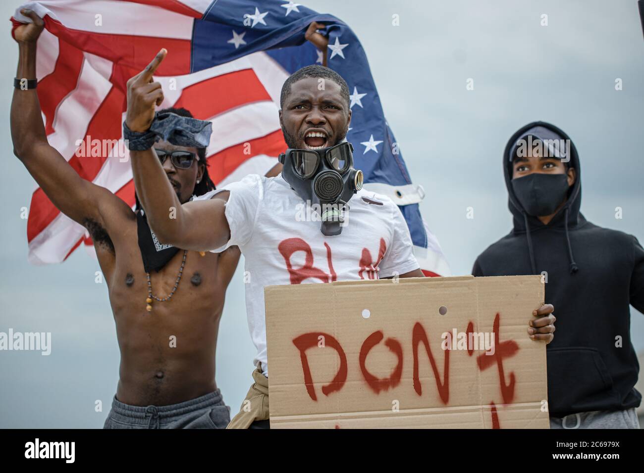 Black lives matter protests go global. three afroamerican people with ...