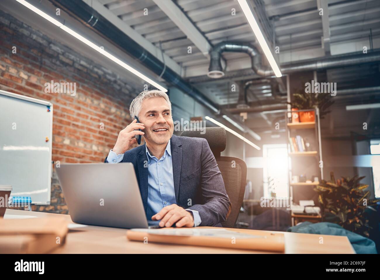 Founder of company enjoying good working day Stock Photo - Alamy