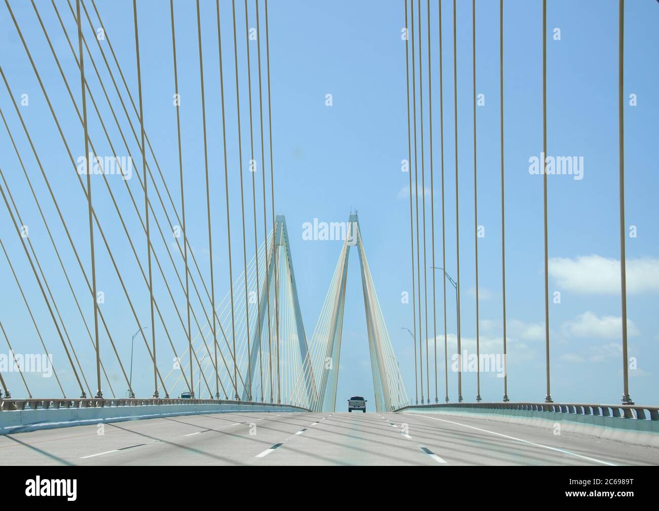 Driving over large cable suspension bridge, with a clear view of the ...