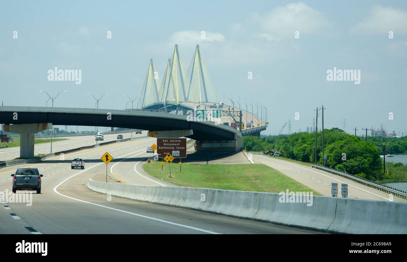 On a highway with a major junction and large cable suspension bridge in ...