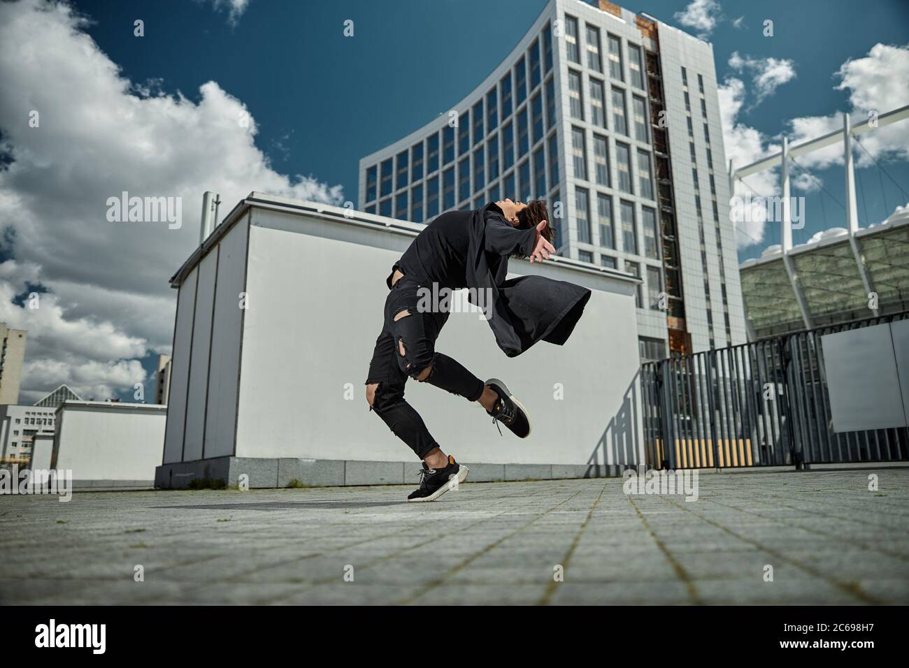 Stylish young man doing tricks on the street Stock Photo - Alamy