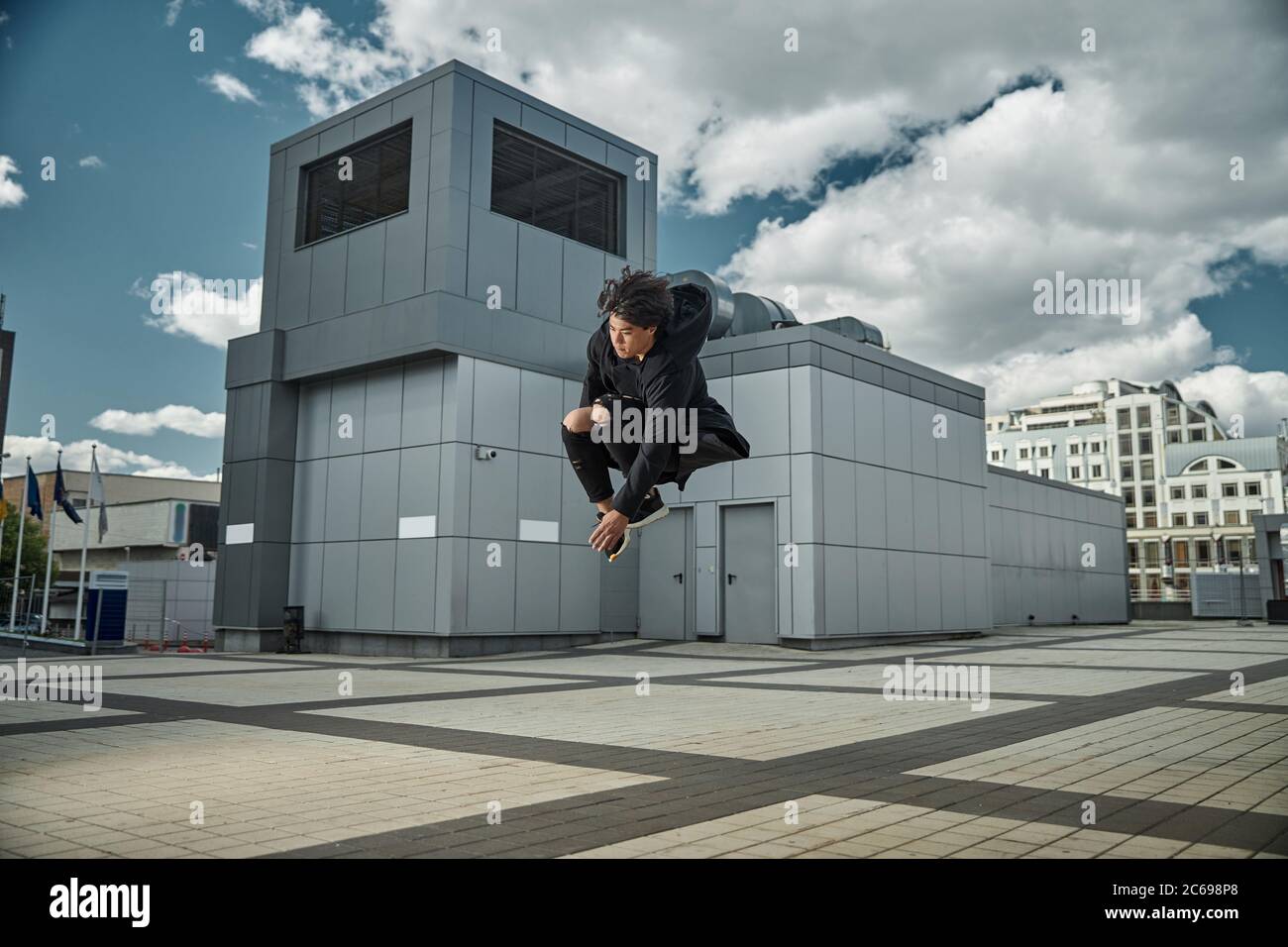 Stylish young man jumping on the street Stock Photo - Alamy
