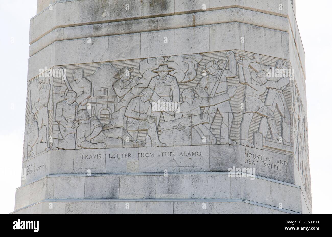 A detail of the San Jacinto Monument with an engraving titled Travis ...