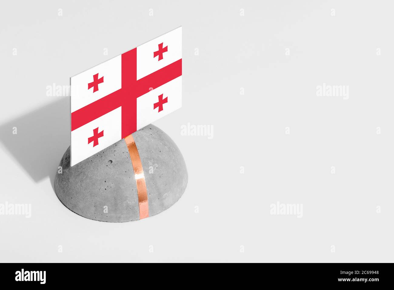 Georgia flag tagged on rounded stone. White isolated background. Side ...