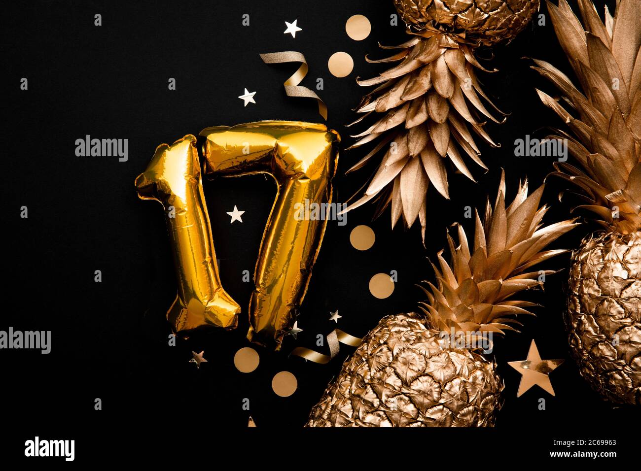 17th birthday celebration background with gold balloons and golden ...