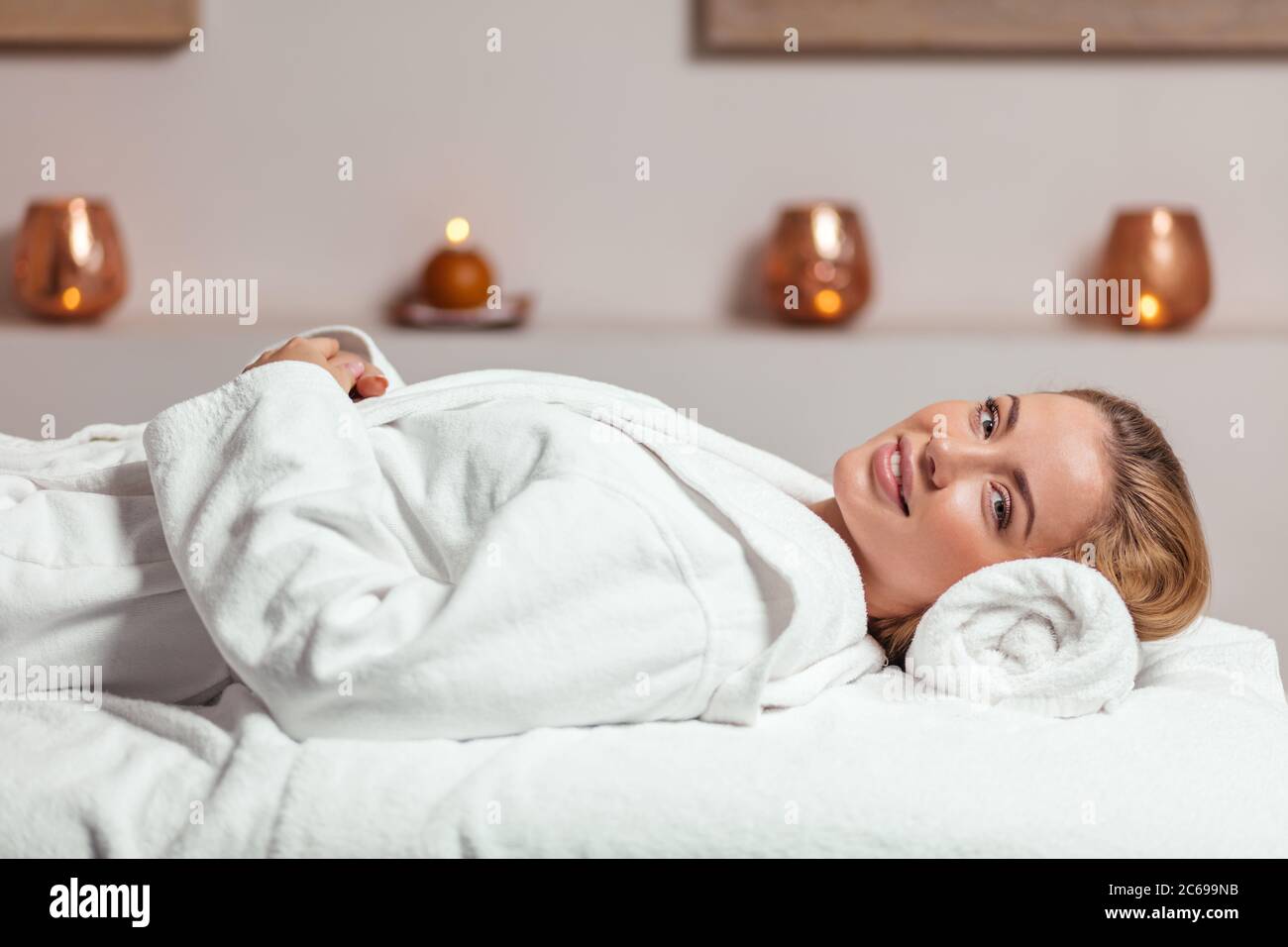 positive charming blond girl spending time at beauty salon and waiting ...