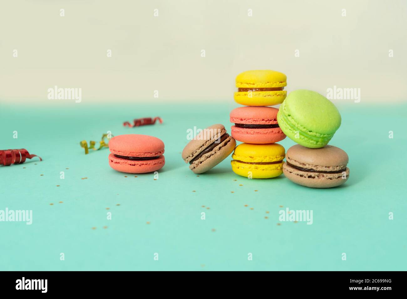 Sweet and colourful french macaroons on turquoise background with ...