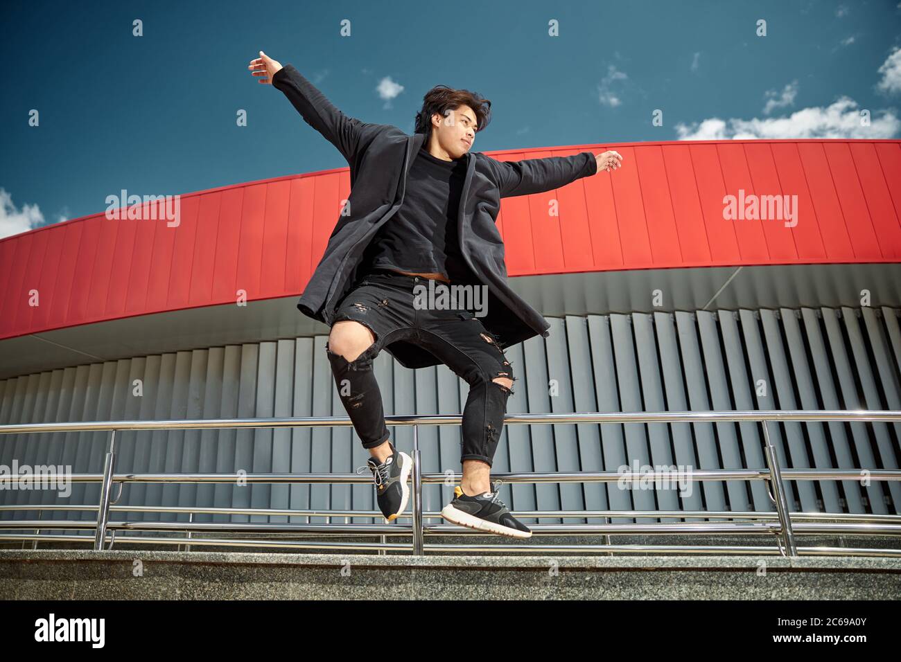 Carefree young man jumping on the street Stock Photo - Alamy