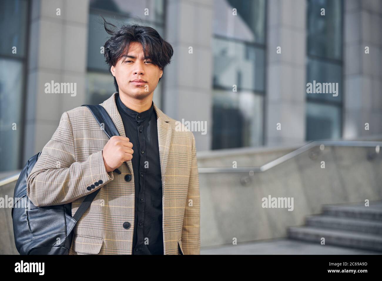 Good-looking young man standing on the street Stock Photo - Alamy