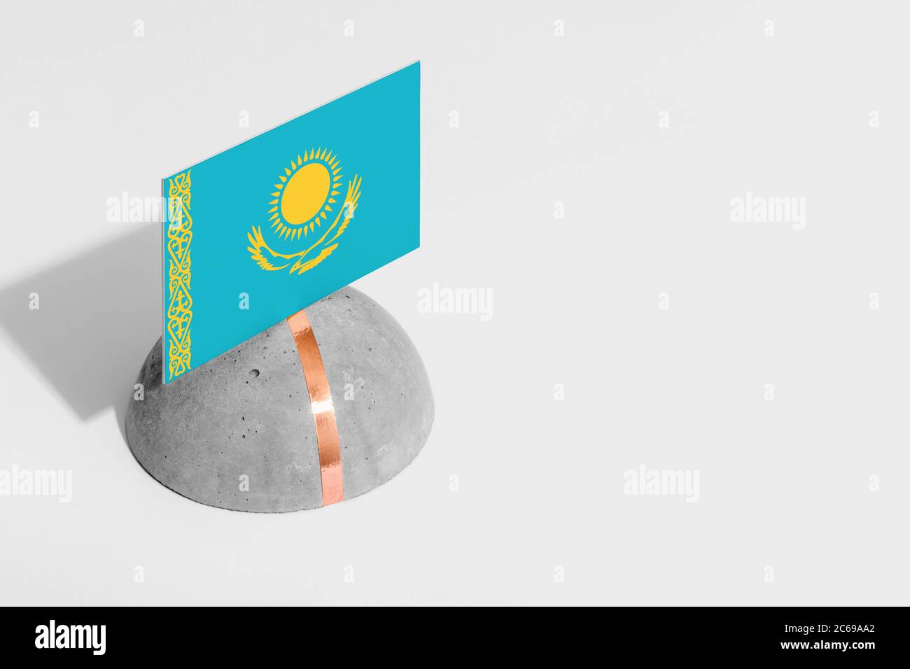Kazakhstan flag tagged on rounded stone. White isolated background ...
