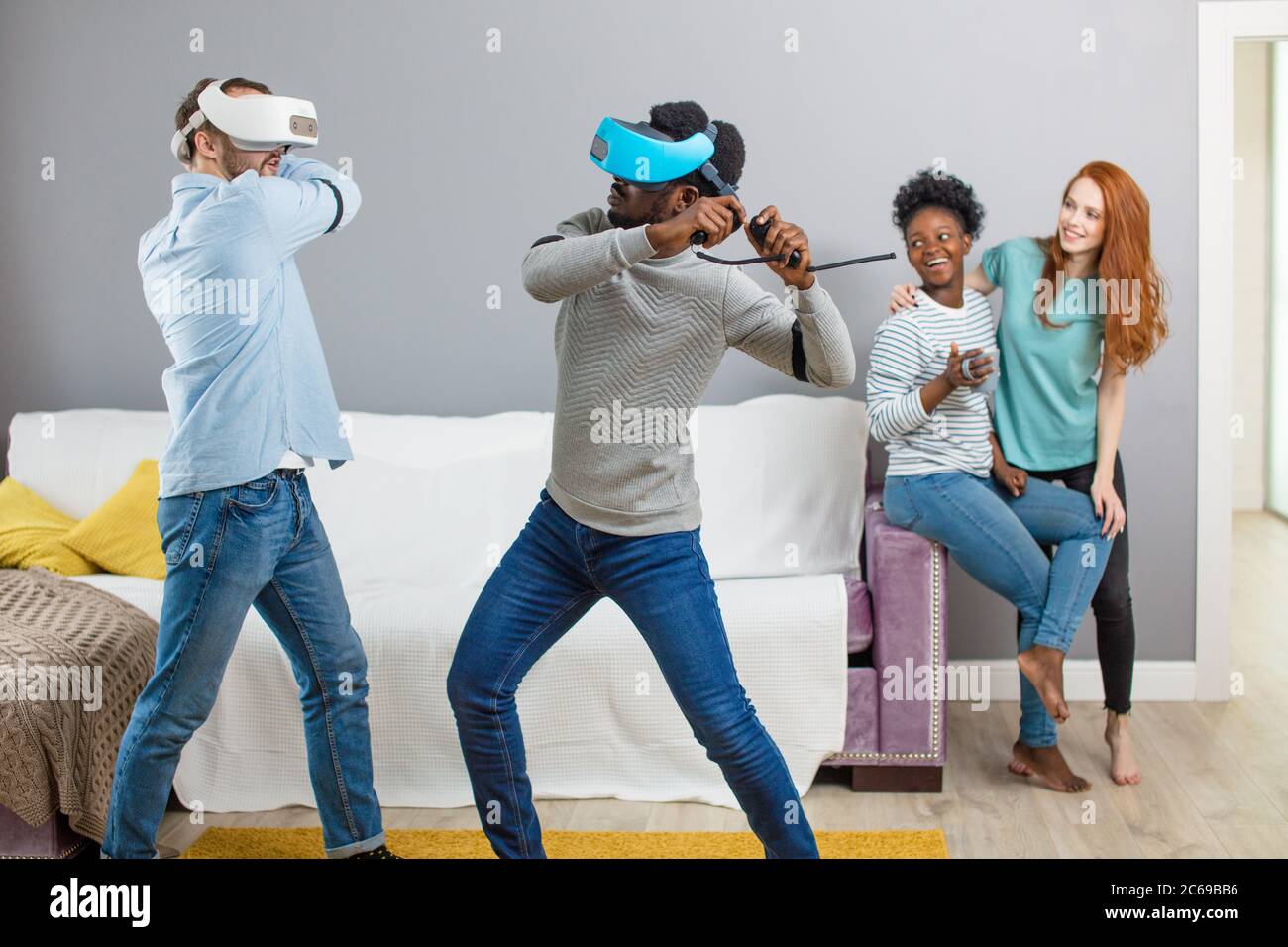 Group of multiracial male amd female students playing virtual game ...