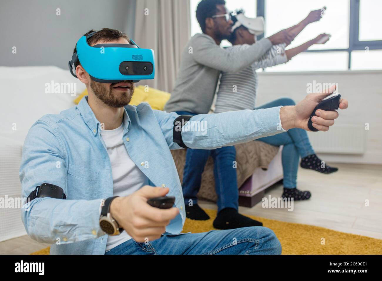 Group of multucultural friends having fun at home playing 3D game using ...