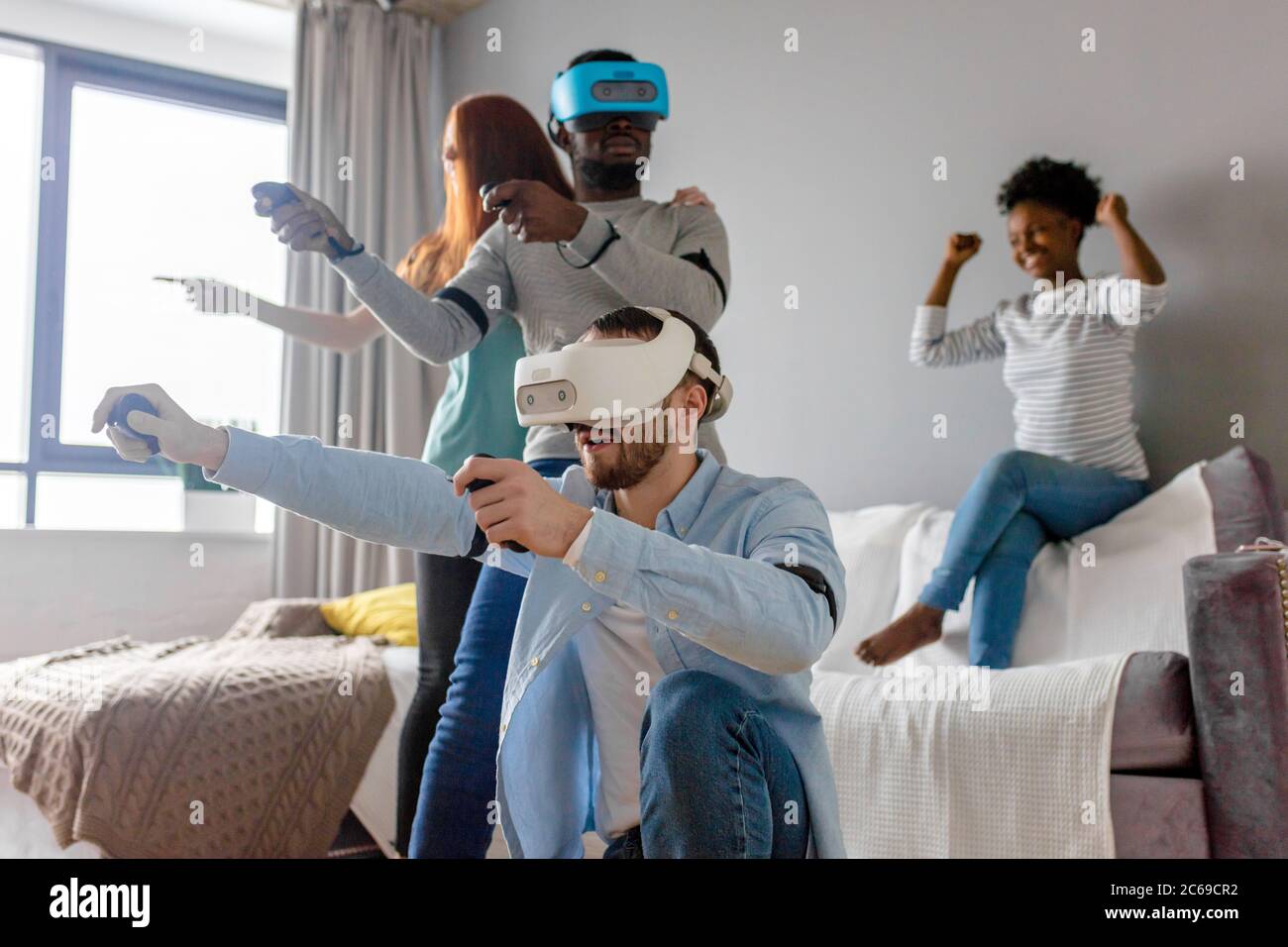 Multiethnic diverse friends enjoying VR technology, two guys wearing vr ...
