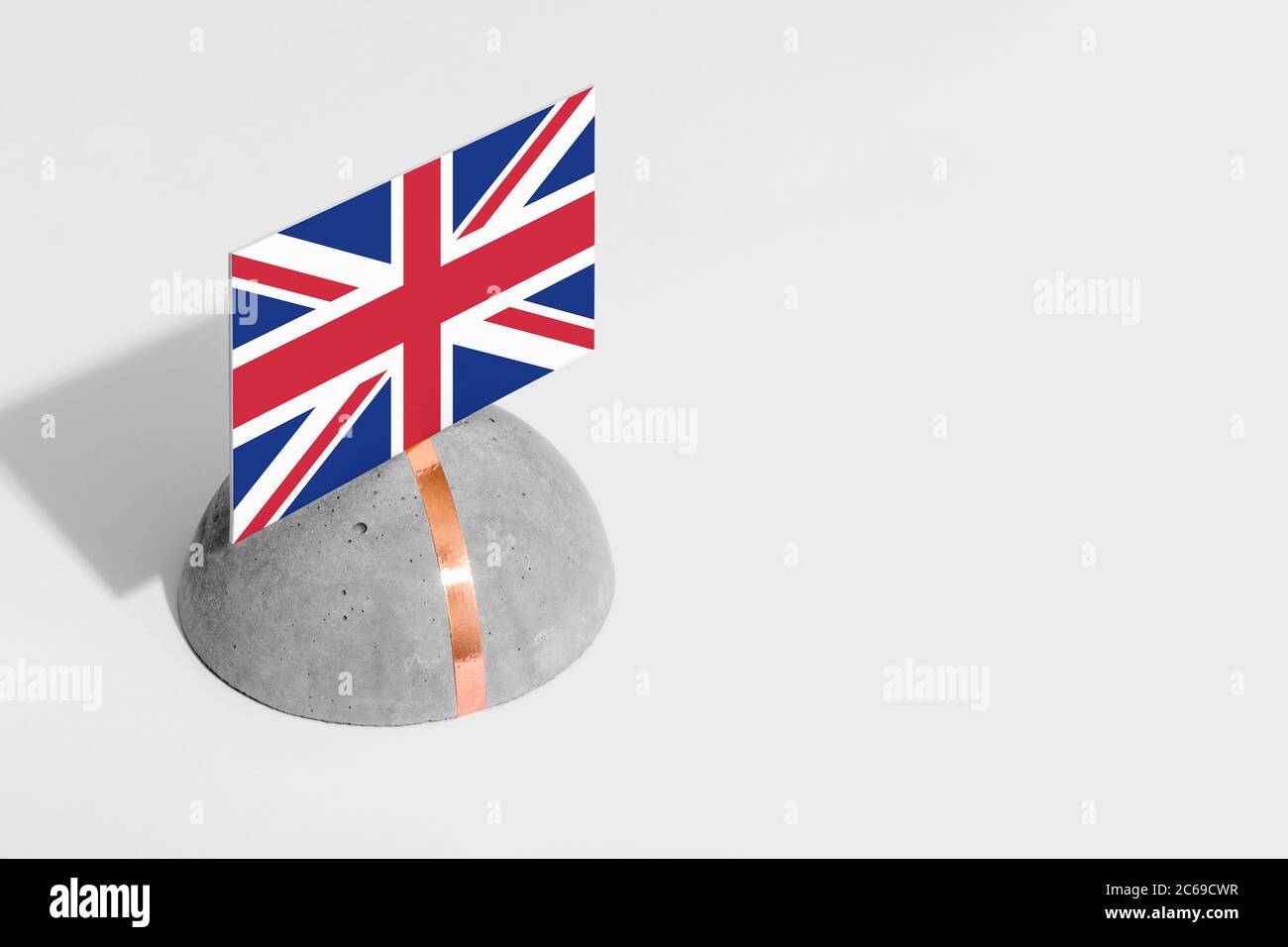 United Kingdom flag tagged on rounded stone. White isolated background ...