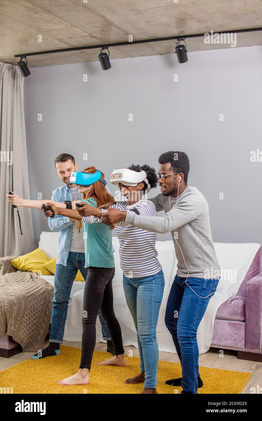 Group of young multicultural diverse friends play at home with internet ...