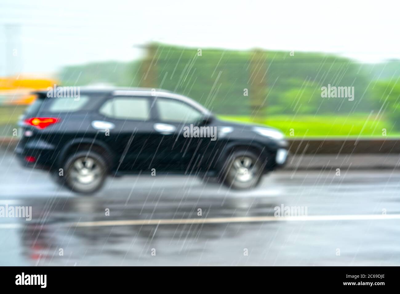 Silhouette of fast cars on the boulevard in the rain with splashing ...