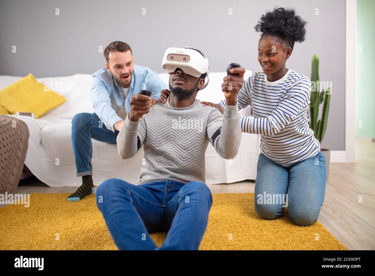 Happy smiling multicultural friends trying on 3D virtual reality ...